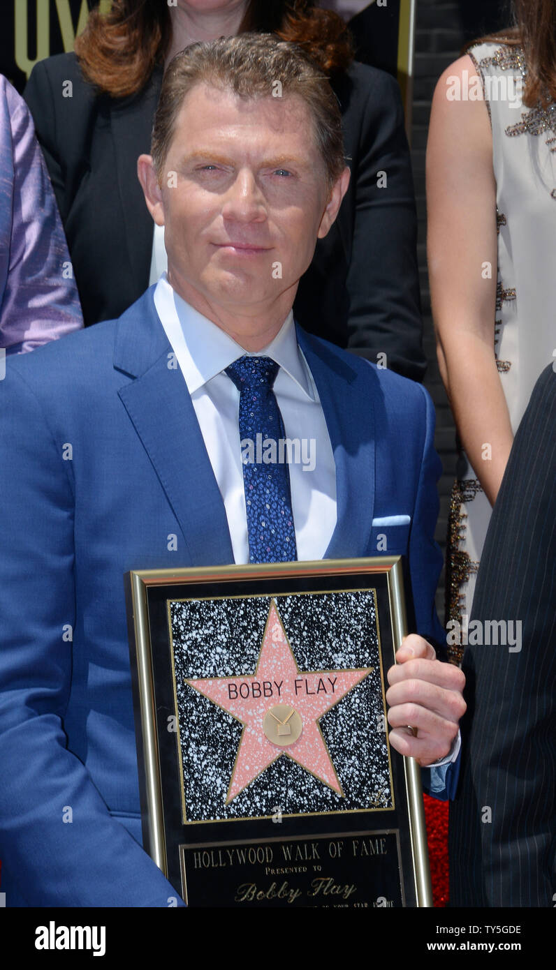 Celebrity chef Bobby Flay holds a replica plaque during an unveiling ...