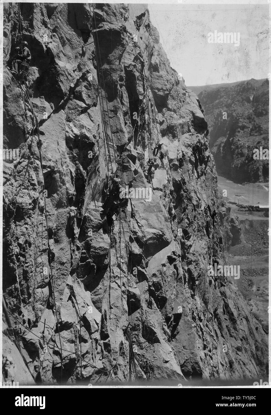 High scalers cleaning canyon wall above Nevada power plant site.; Scope ...