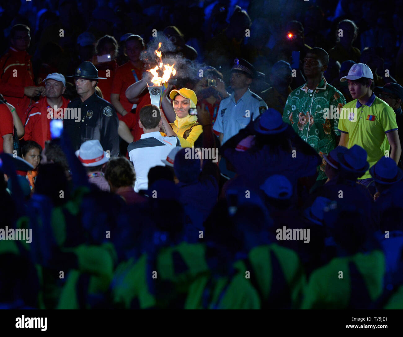 The torch enters the Coliseum at the conclusion of opening ceremonies ...