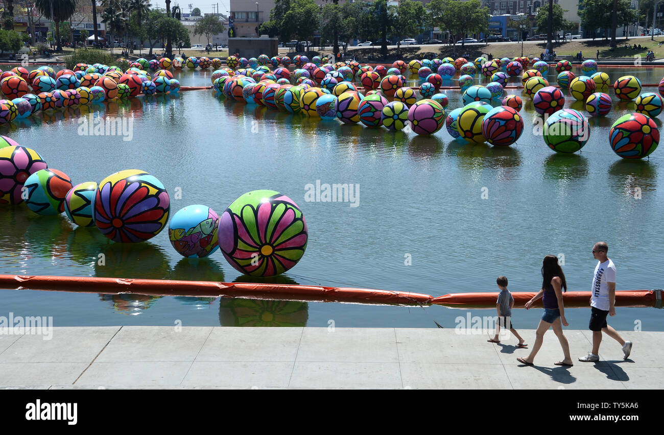Giant multicolored spheres on display are tethered as part of artist Ed ...