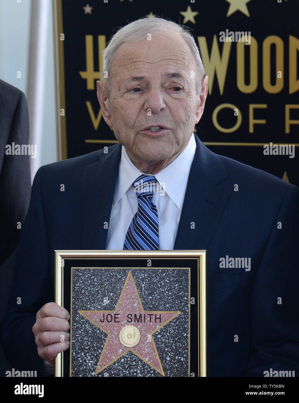 Music executive and producer Joe Smith holds a replica plaque during an ...