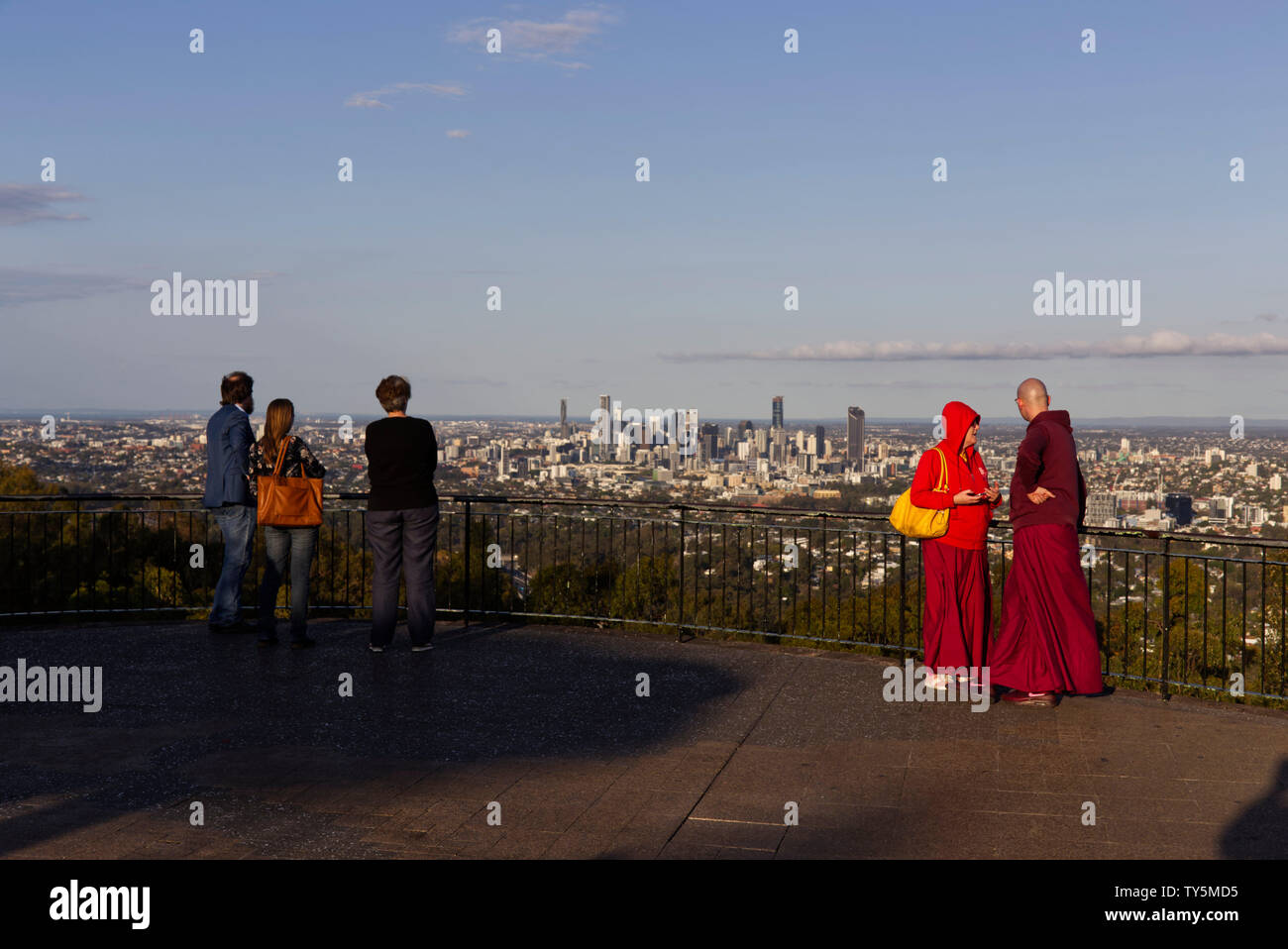 Tourists enjoying the sunset over Brisbane City from the Mt Coot tha ...