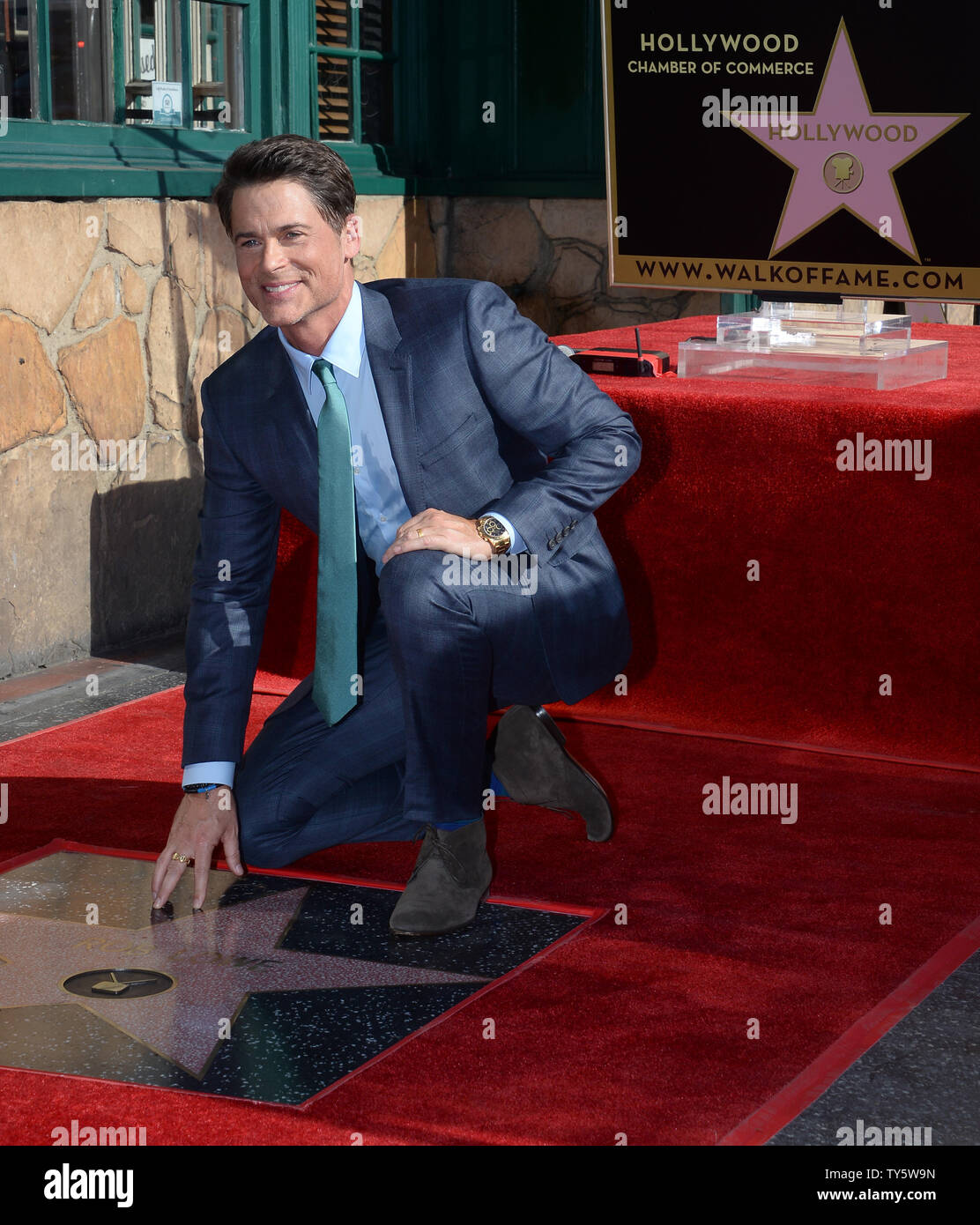 Actor Robe Lowe touches his star during an unveiling ceremony honoring ...