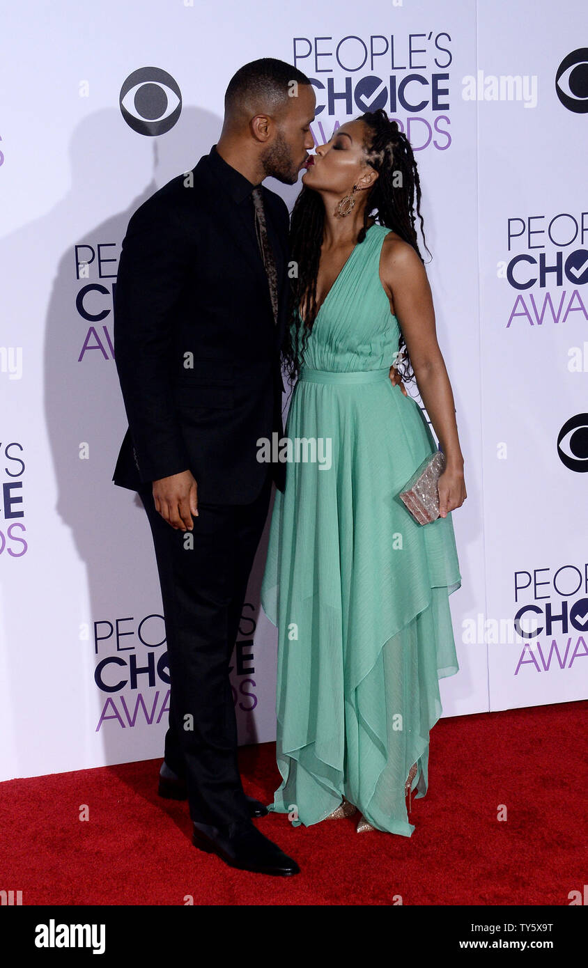 Author DeVon Franklin, left, and actress Meagan Good arrive for the ...