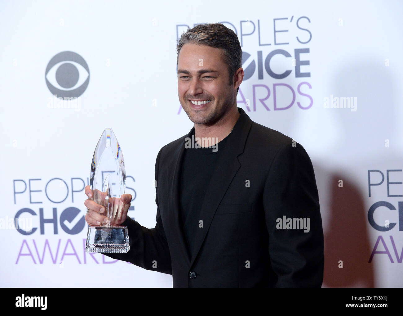Actor Taylor Kinney appears backstage with his award for Favorite ...