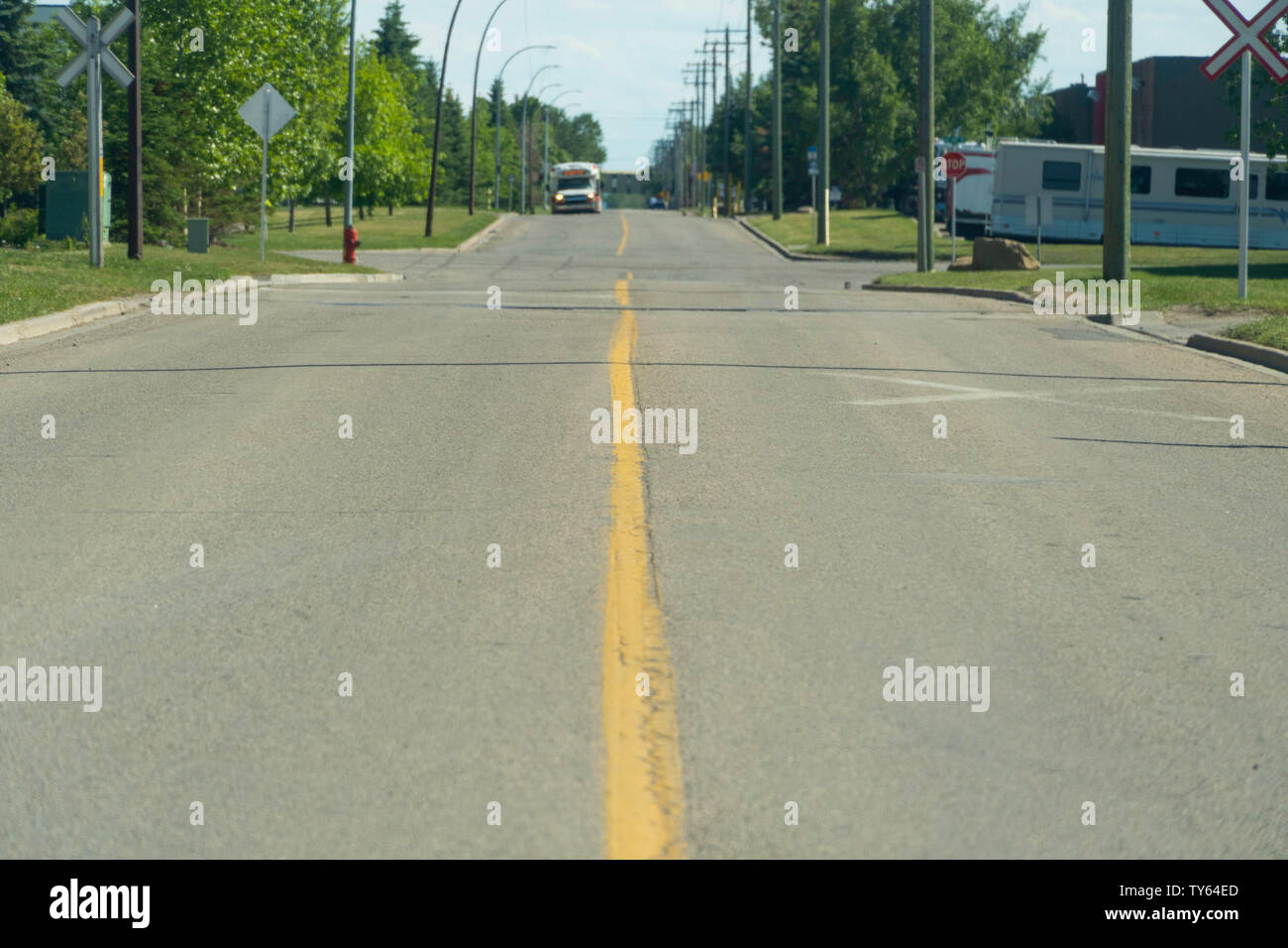 City transport bus approaching an intersection on the road Stock Photo ...