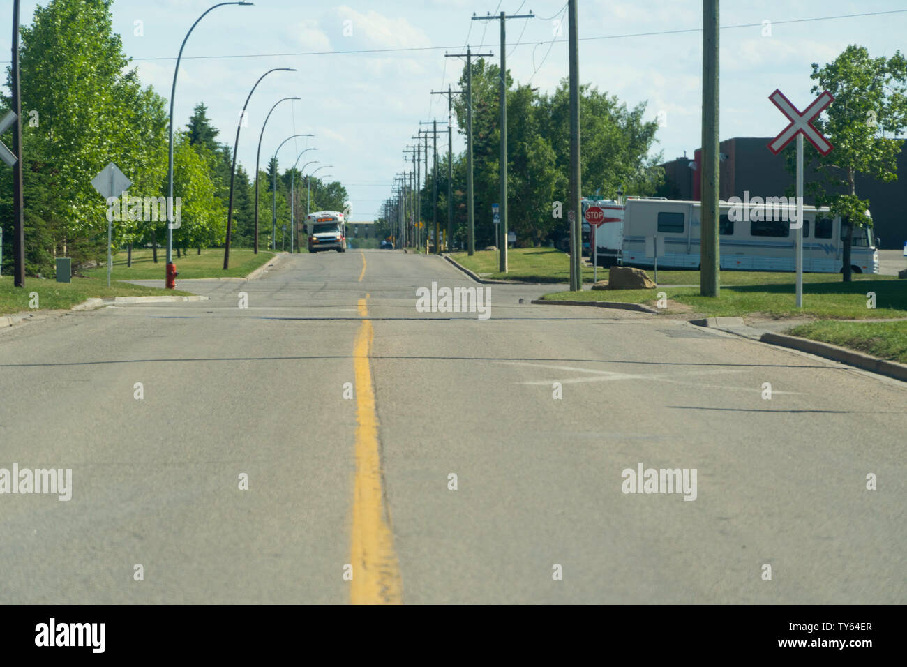 City transport bus approaching an intersection on the road Stock Photo ...