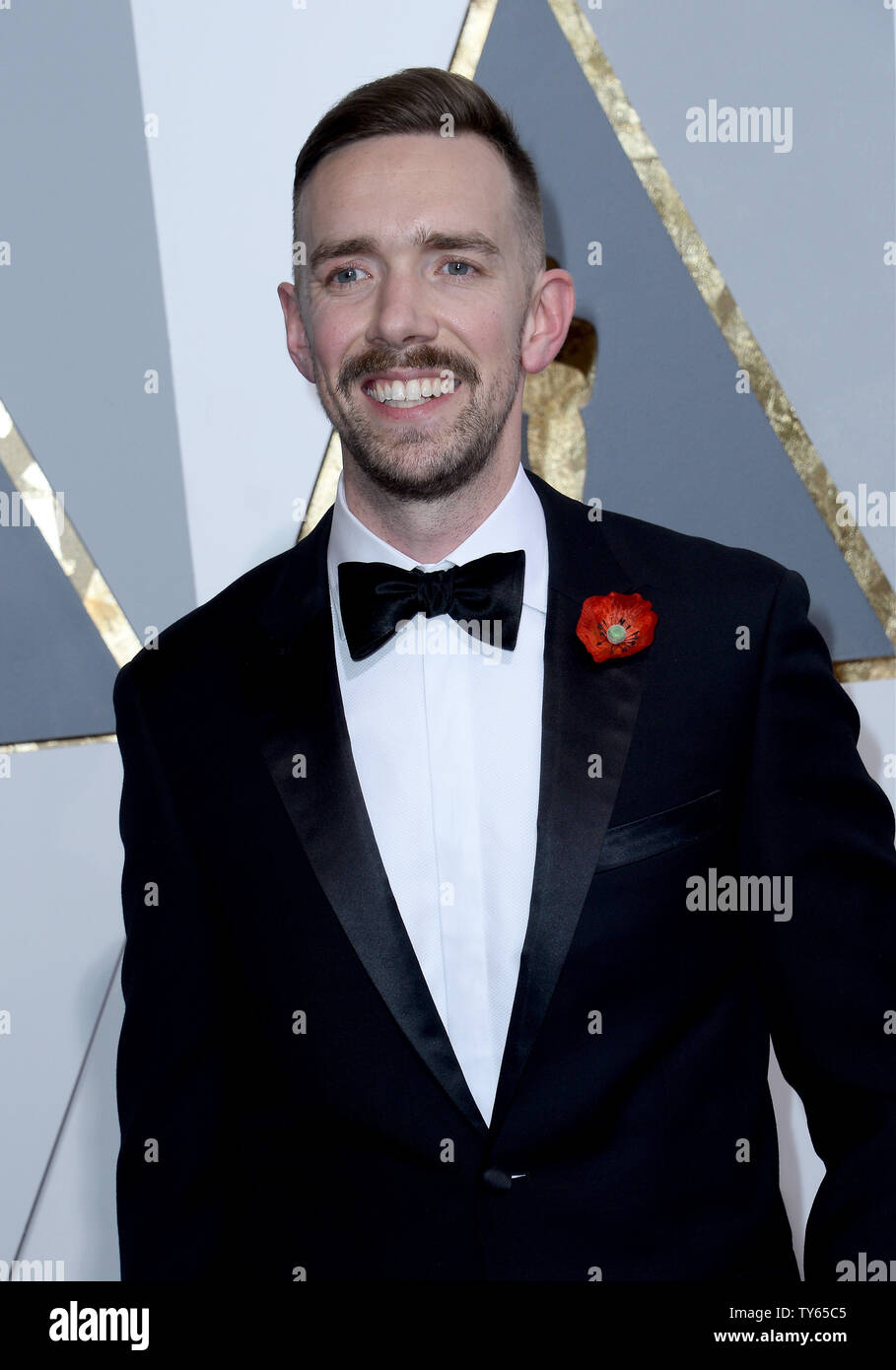 Director Henry Hughes arrives on the red carpet for the 88th Academy ...