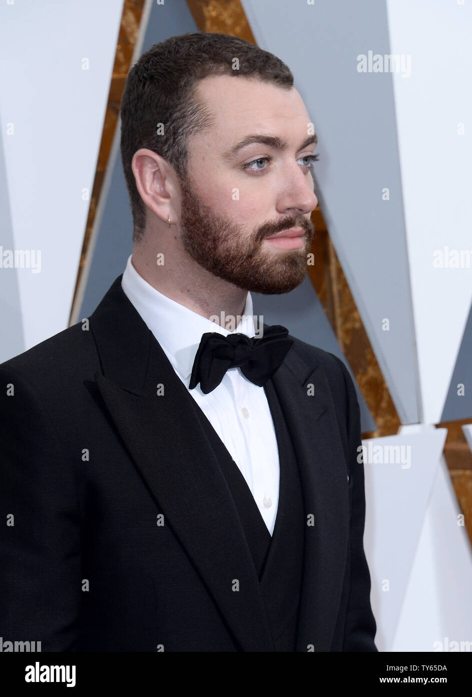Singer Sam Smith arrives on the red carpet for the 88th Academy Awards ...