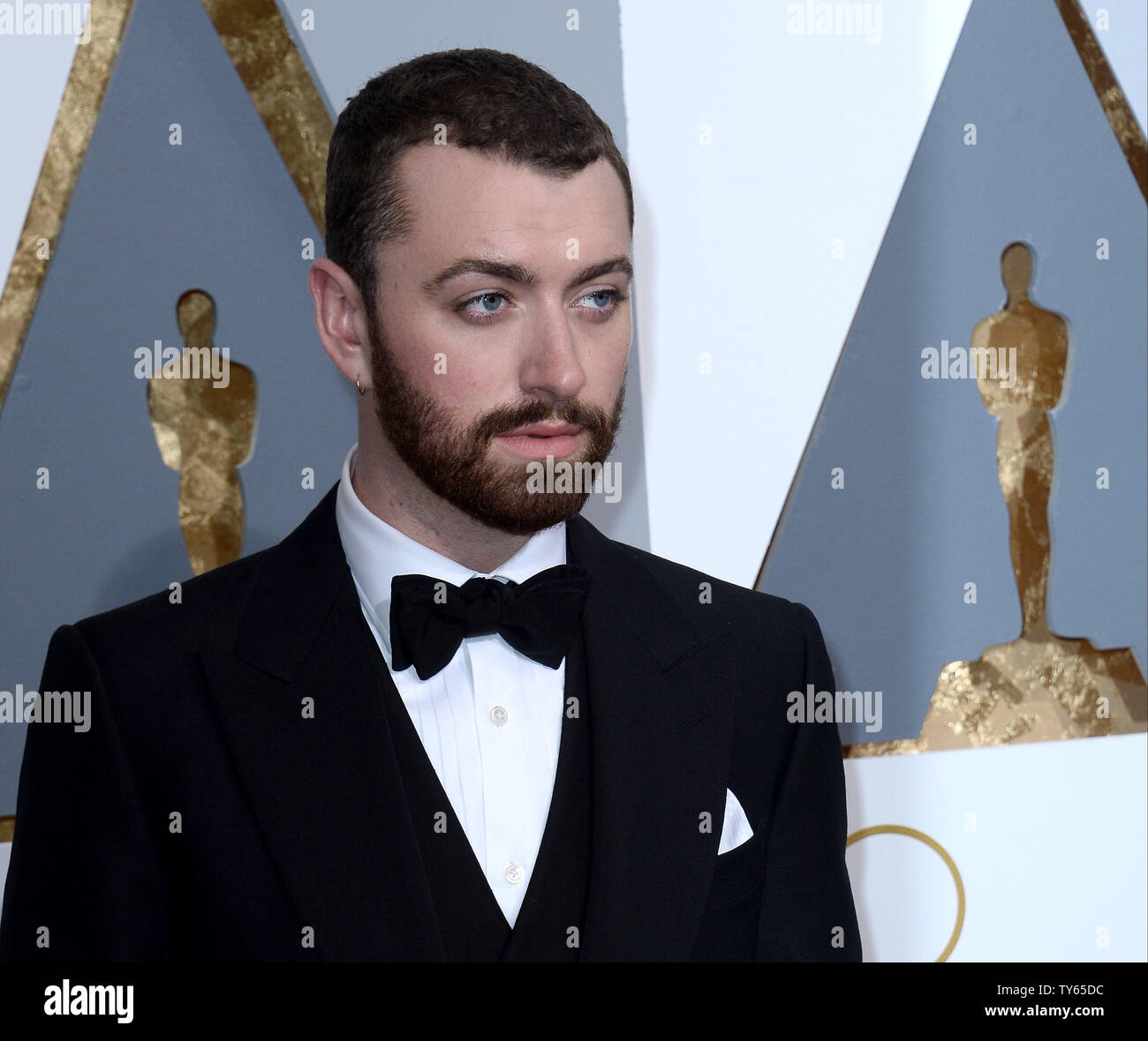 Singer Sam Smith arrives on the red carpet for the 88th Academy Awards ...