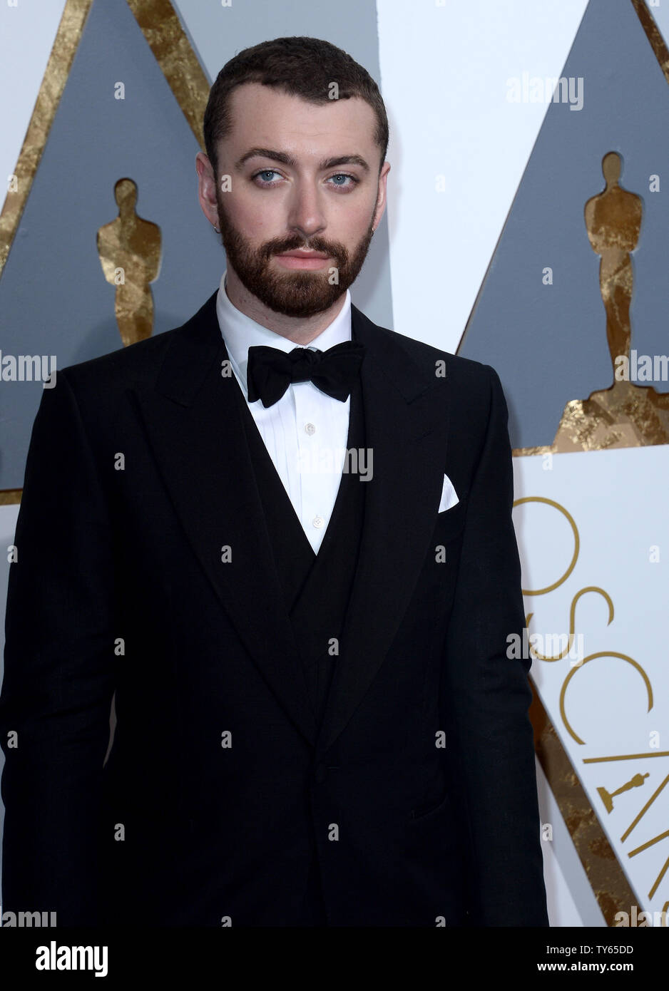 Singer Sam Smith arrives on the red carpet for the 88th Academy Awards ...
