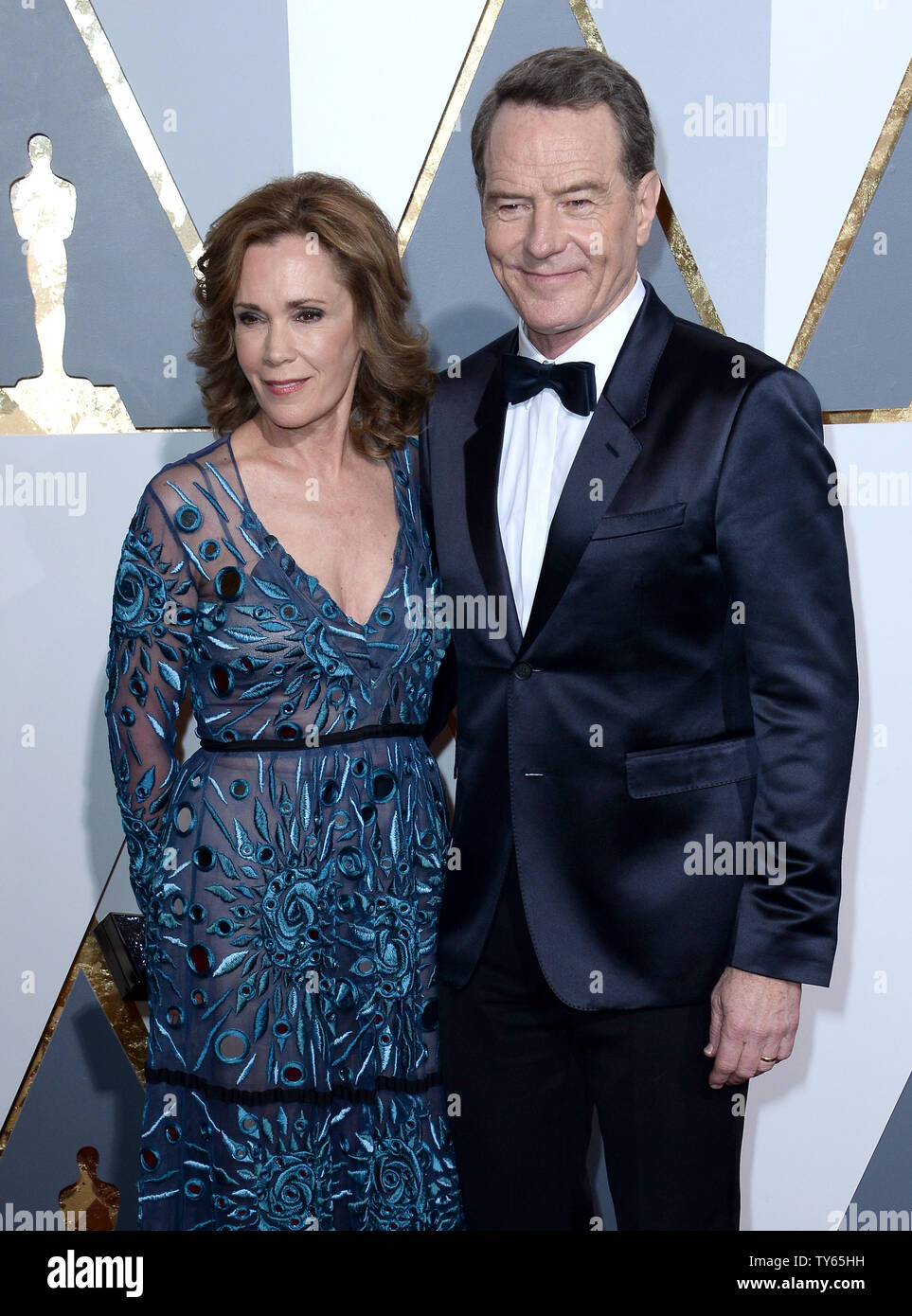 Robin Dearden, left, and actor Bryan Cranston arrive on the red carpet ...