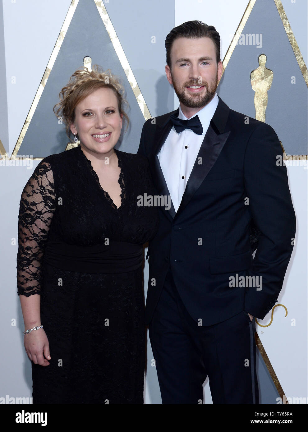 Carly Evans and actor Chris Evans, right, arrive on the red carpet for ...