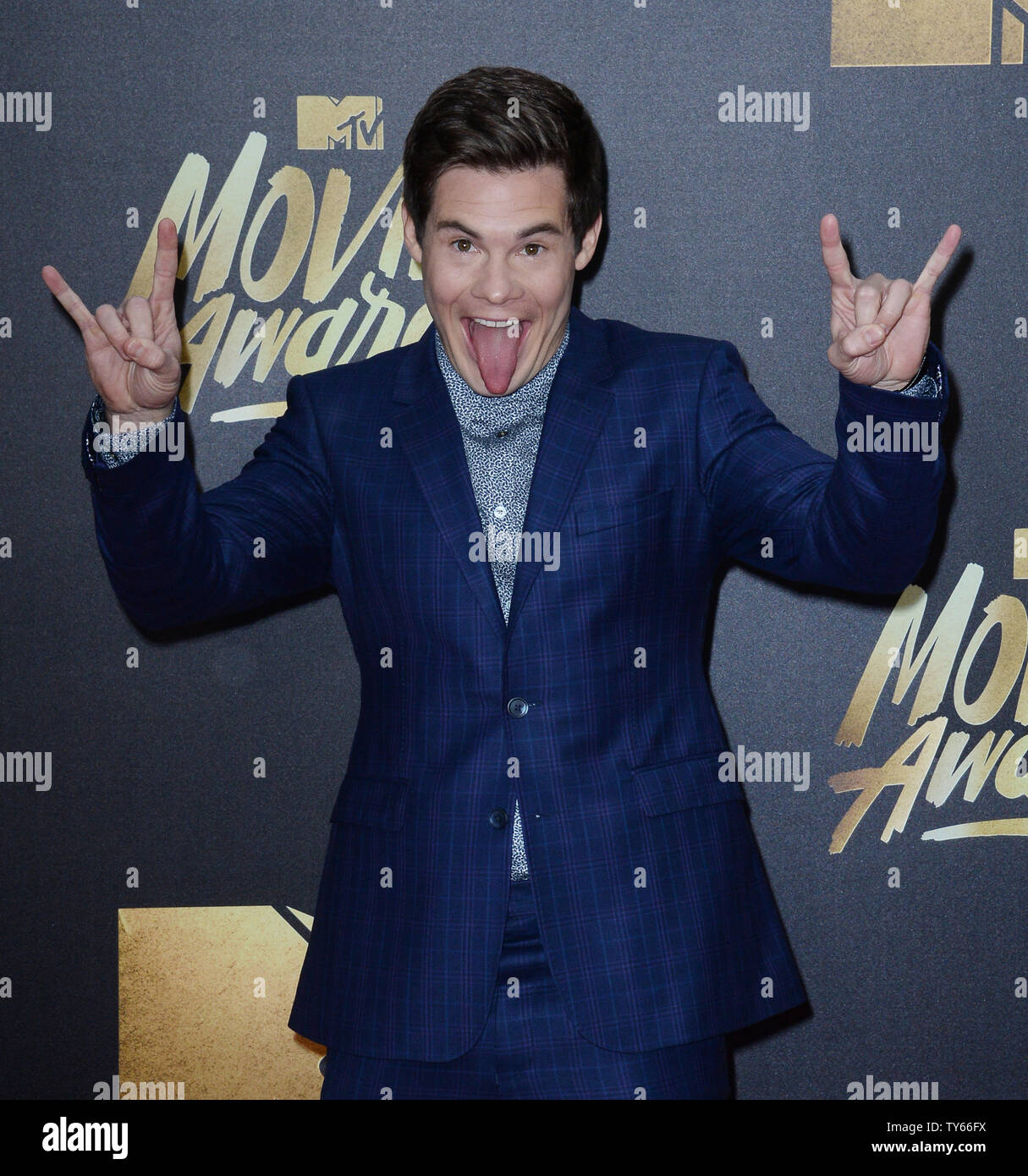 Actor Adam DeVine attends the MTV Movie Awards at Warner Bros. Studios ...