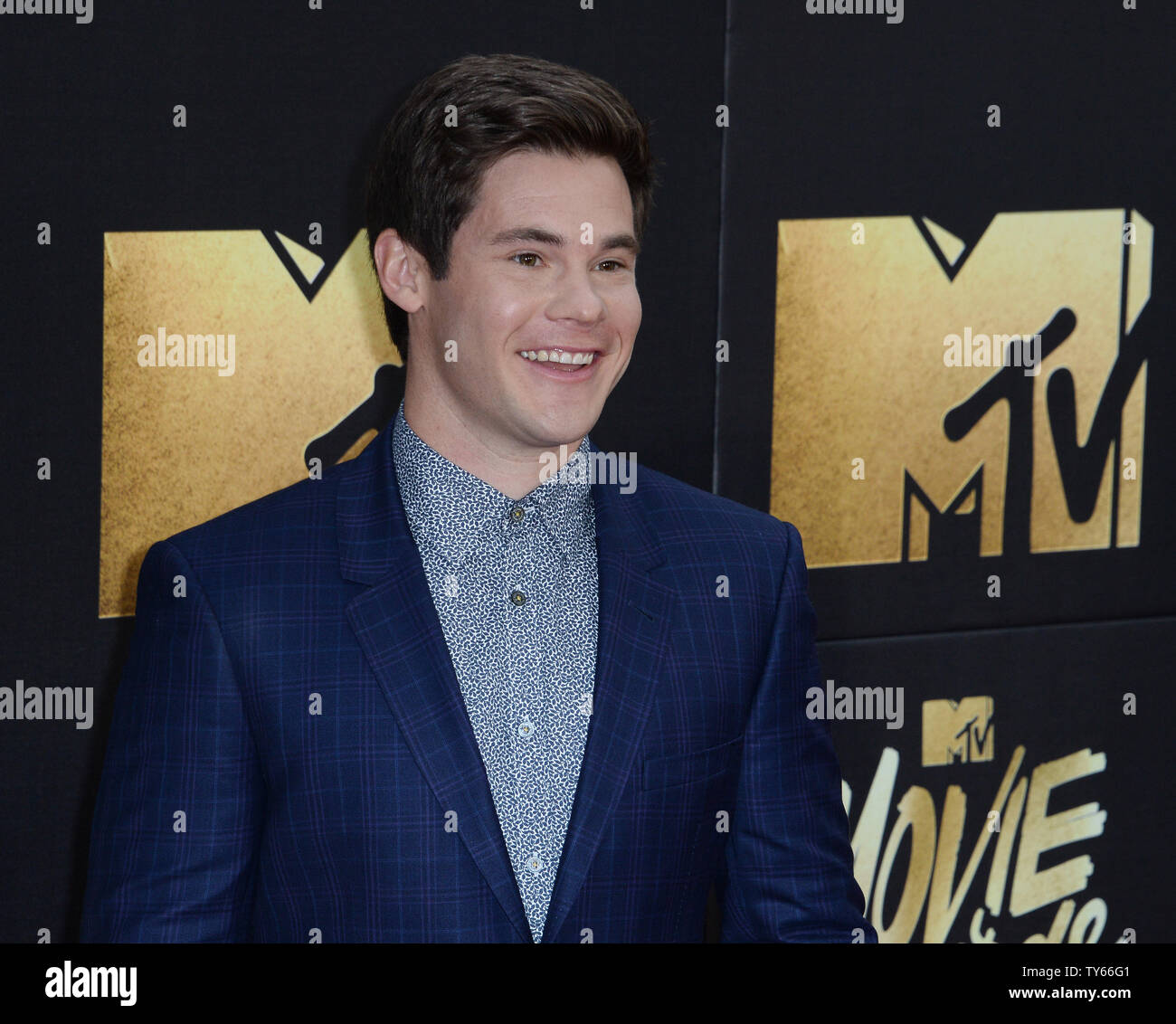 Actor Adam DeVine attends the MTV Movie Awards at Warner Bros. Studios ...