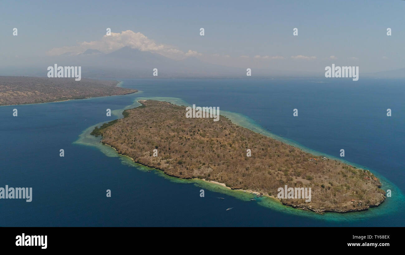 coastline island with coral reef, beach. Coral reef, atoll on Menjangan ...