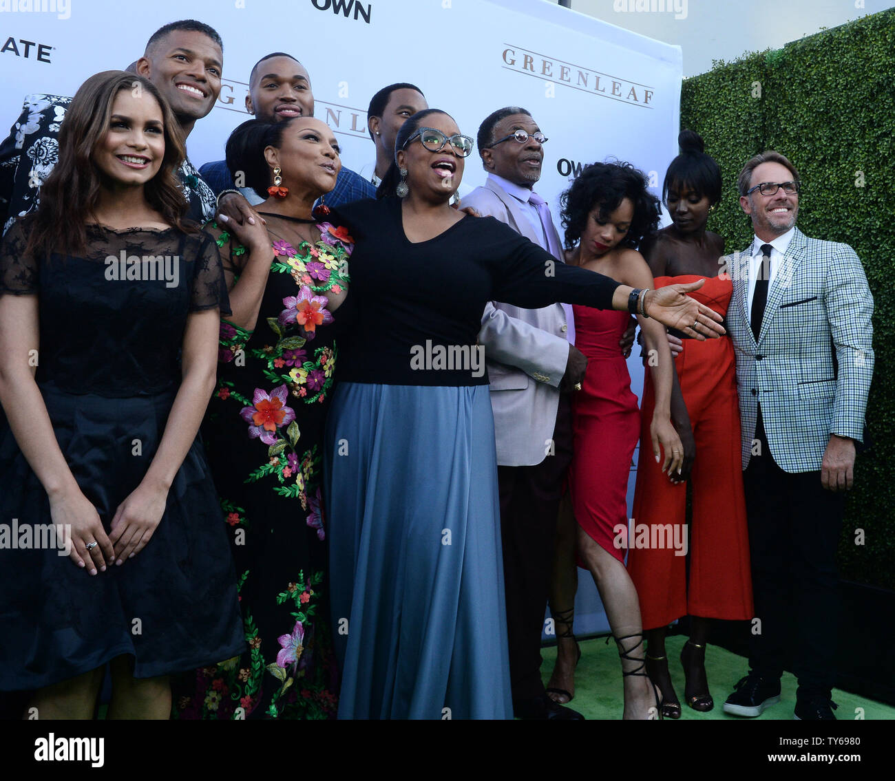 Oprah Winfrey (C) joins cast members on the green carpet during the ...