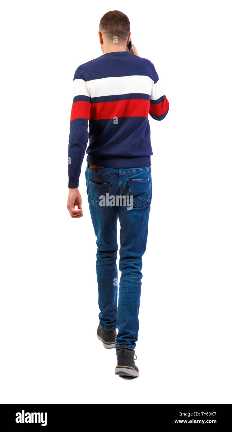 Back view of man walking with a mobile phone. backside view of person ...