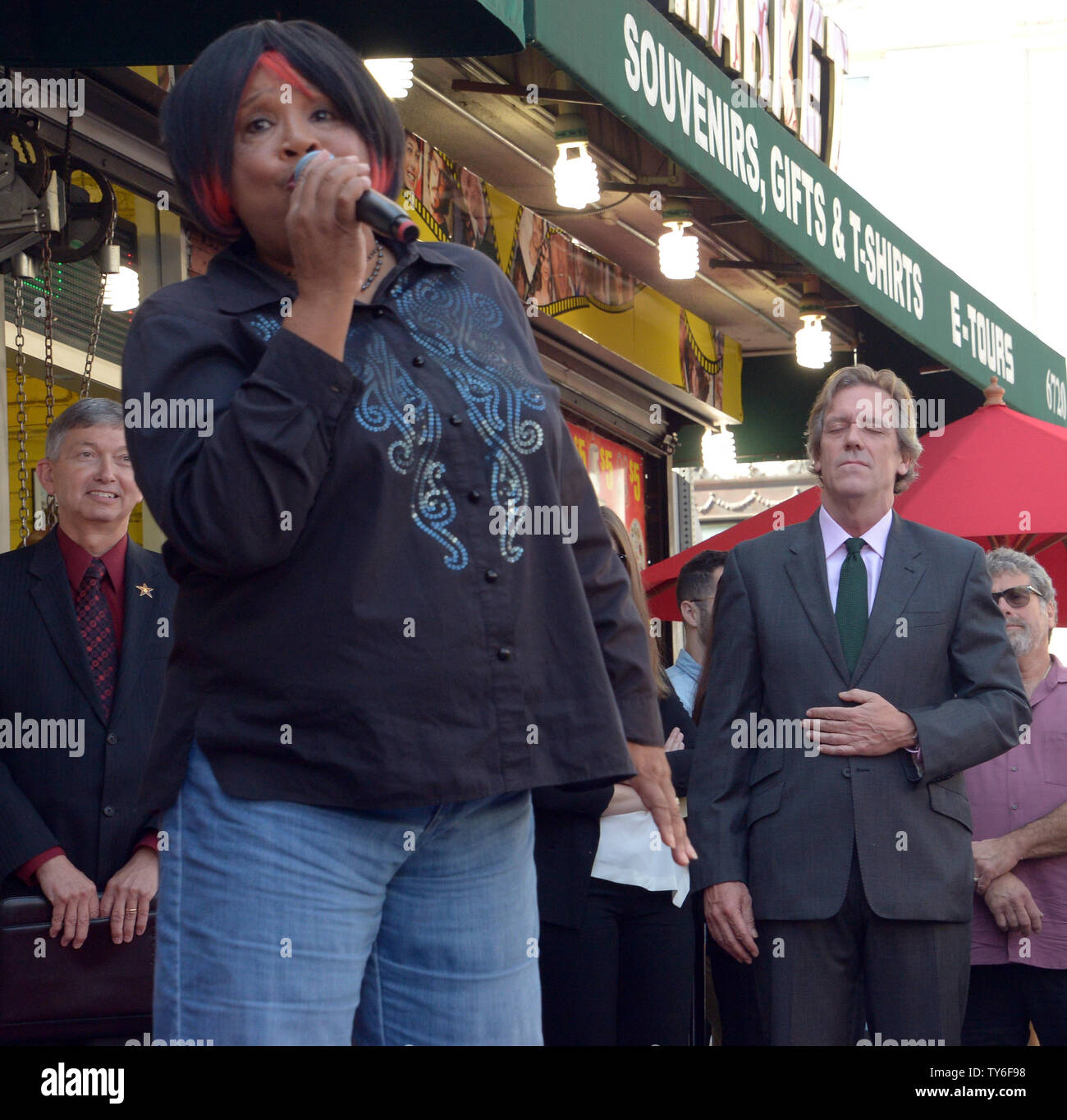 Singer Pepper Mashay serenades English actor Hugh Laurie during an ...