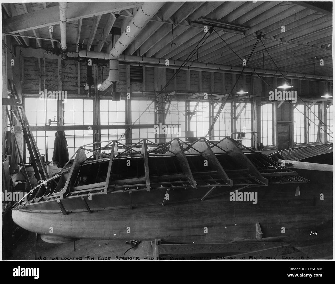 Jig for locating fin edge of stringer and for giving correct contour to ...