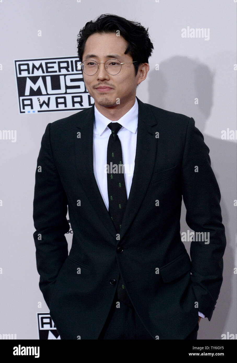 Actor Steven Yeun arrives for the 2016 American Music Awards held at ...