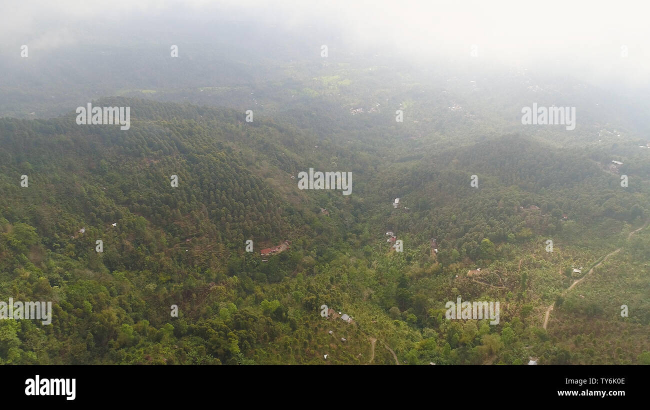 rural landscape mountains with farmlands, village, fields with crops ...
