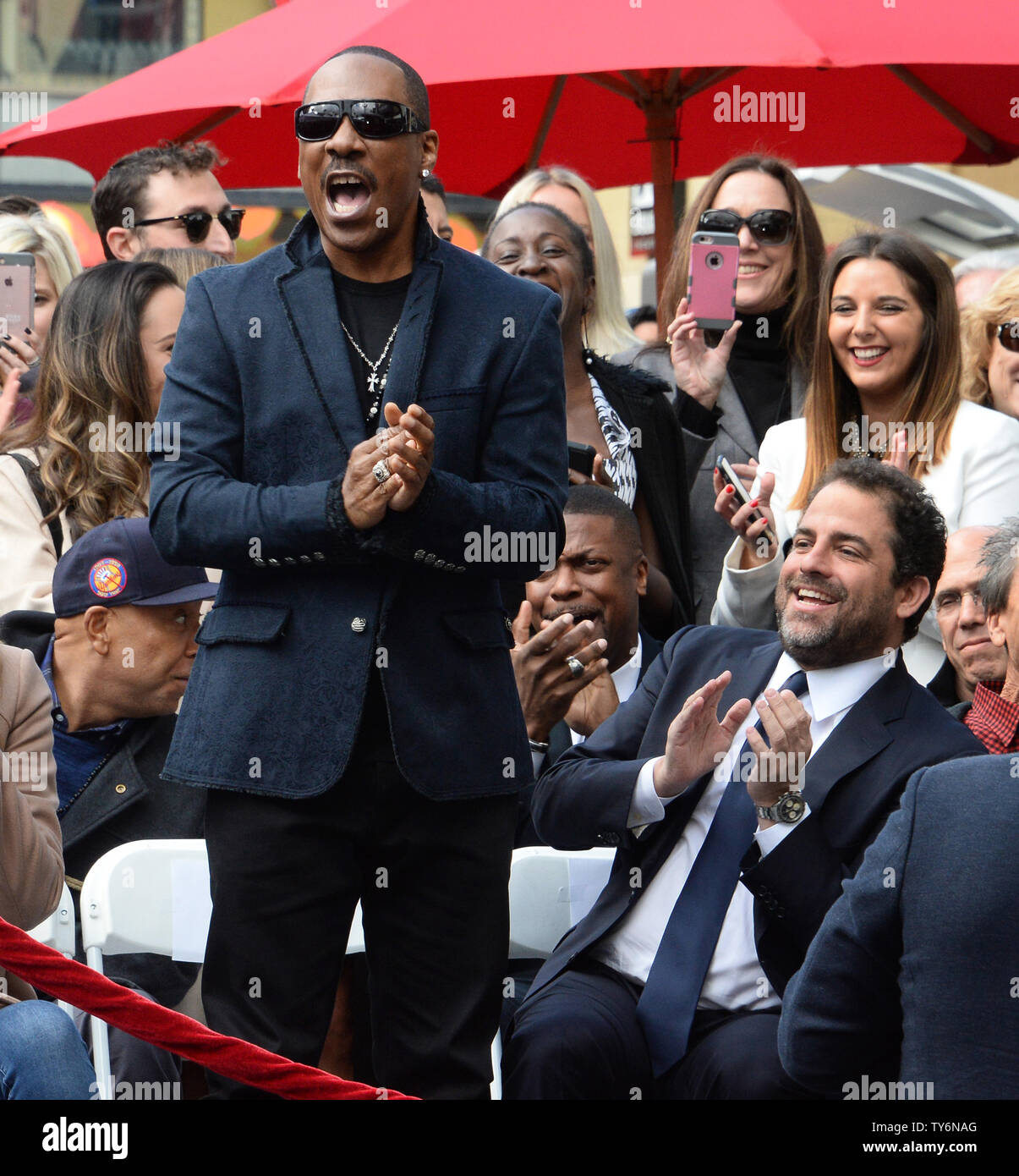 Actor Eddie Murphy L) is introduced as director Brett Ratner (R) looks ...