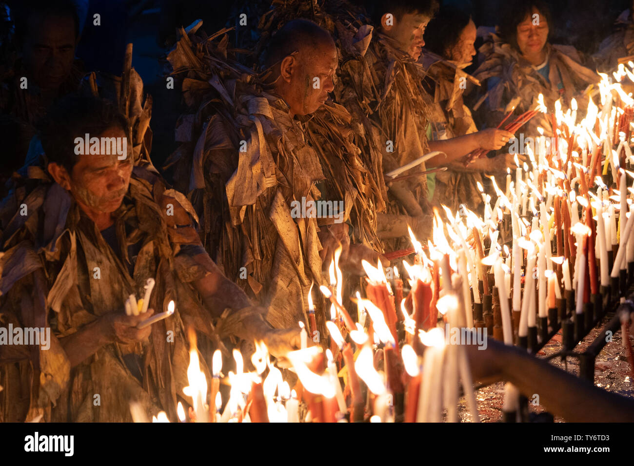 Devotees take part in the ‘Taong Putik’ or mud people festival in the ...
