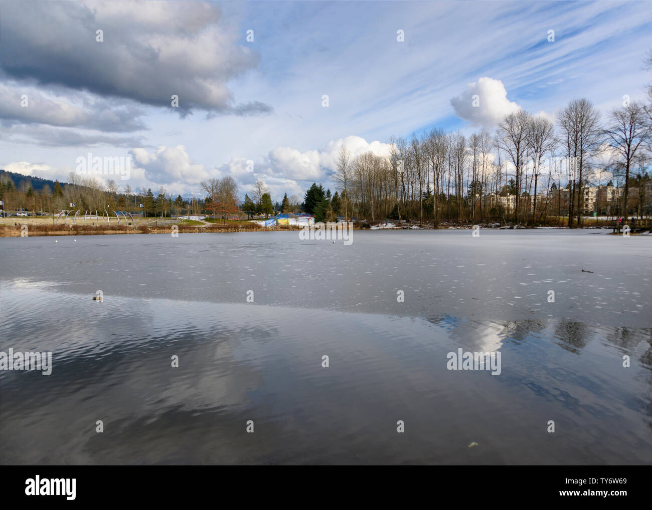 beautiful winter scene with partly frozen lake, covered with shattering ...