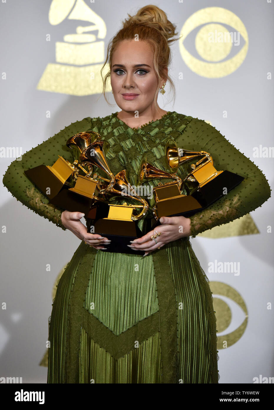 Singer Adele appears backstage with her awards for Album Of The Year ...
