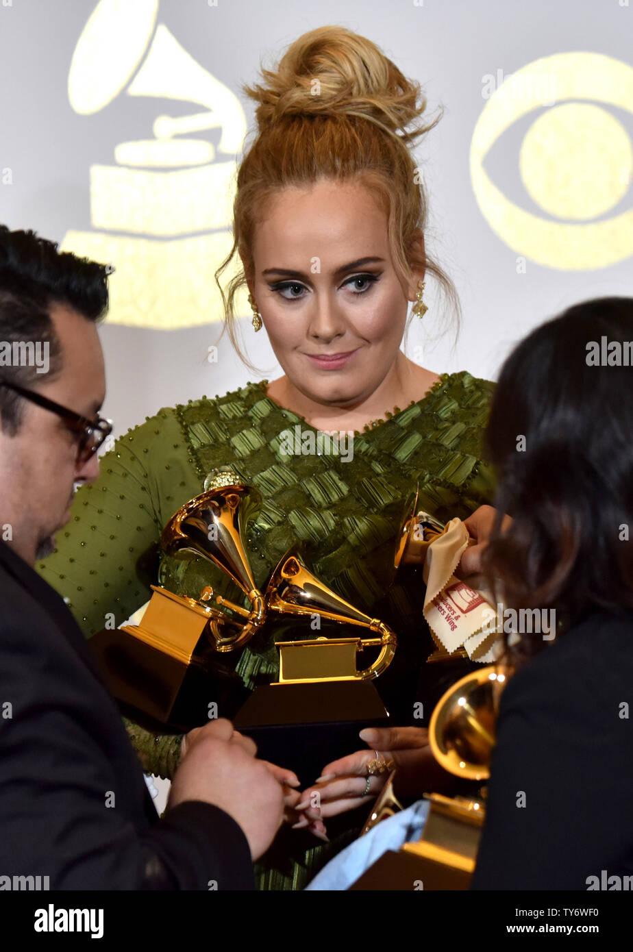 Singer Adele appears backstage with her awards for Album Of The Year ...