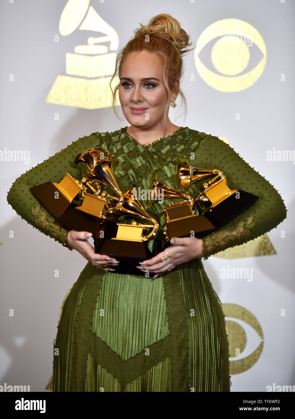 Singer Adele appears backstage with her awards for Album Of The Year ...