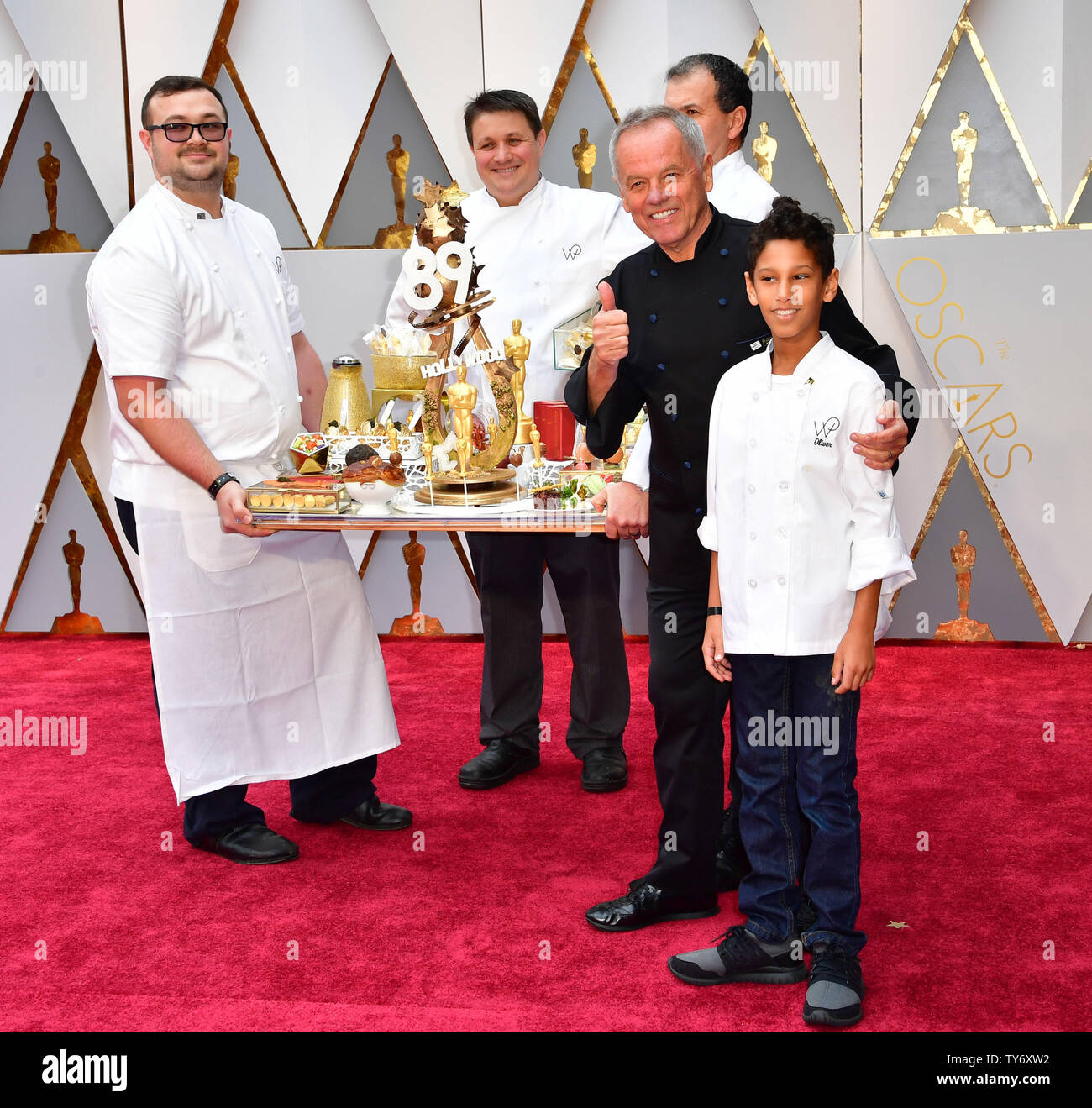 Chef Wolfgang Puck (L) and son Oliver (R) arrives with an assortment of ...