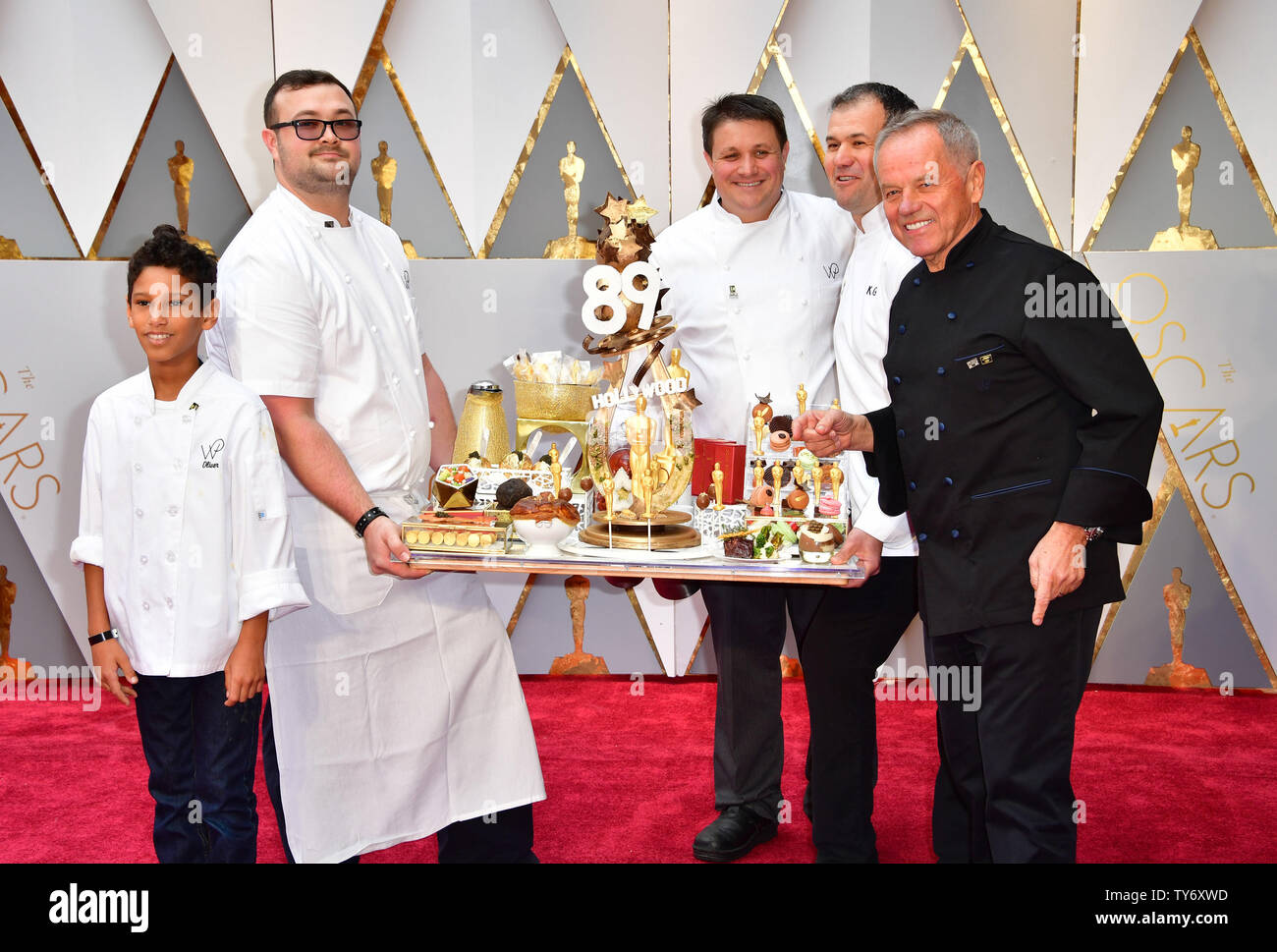 Chef Wolfgang Puck (R) and son Oliver (L) arrives with an assortment of ...
