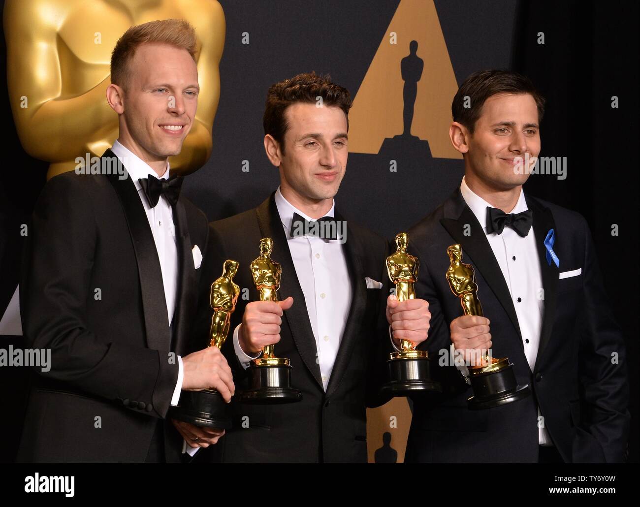 (L-R) Composers Justin Paul, Justin Hurwitz and Benj Pasek, winners of the award for Music ...