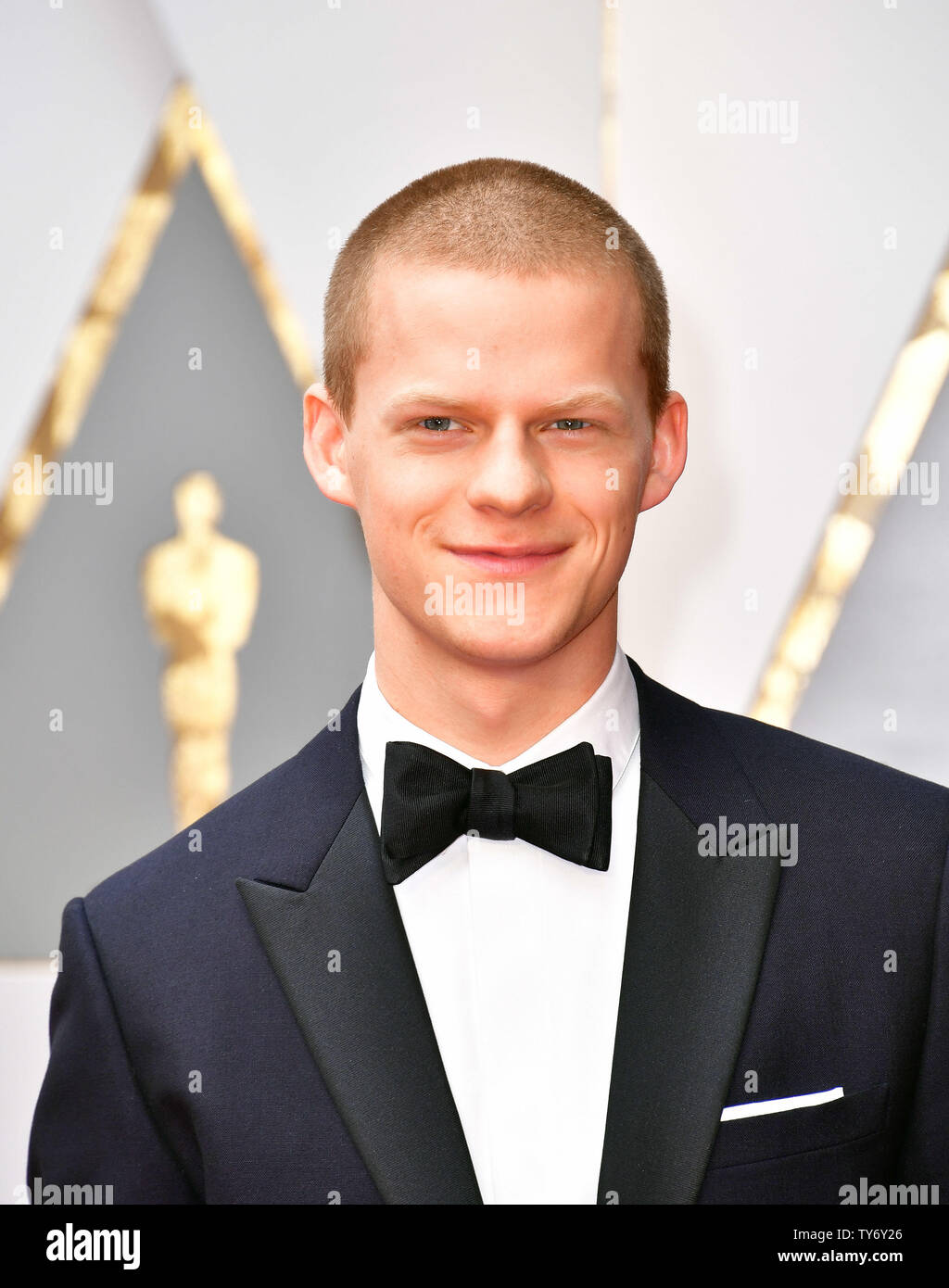 Actor Lucas Hedges arrives with an assortment of Oscar-themed food on ...