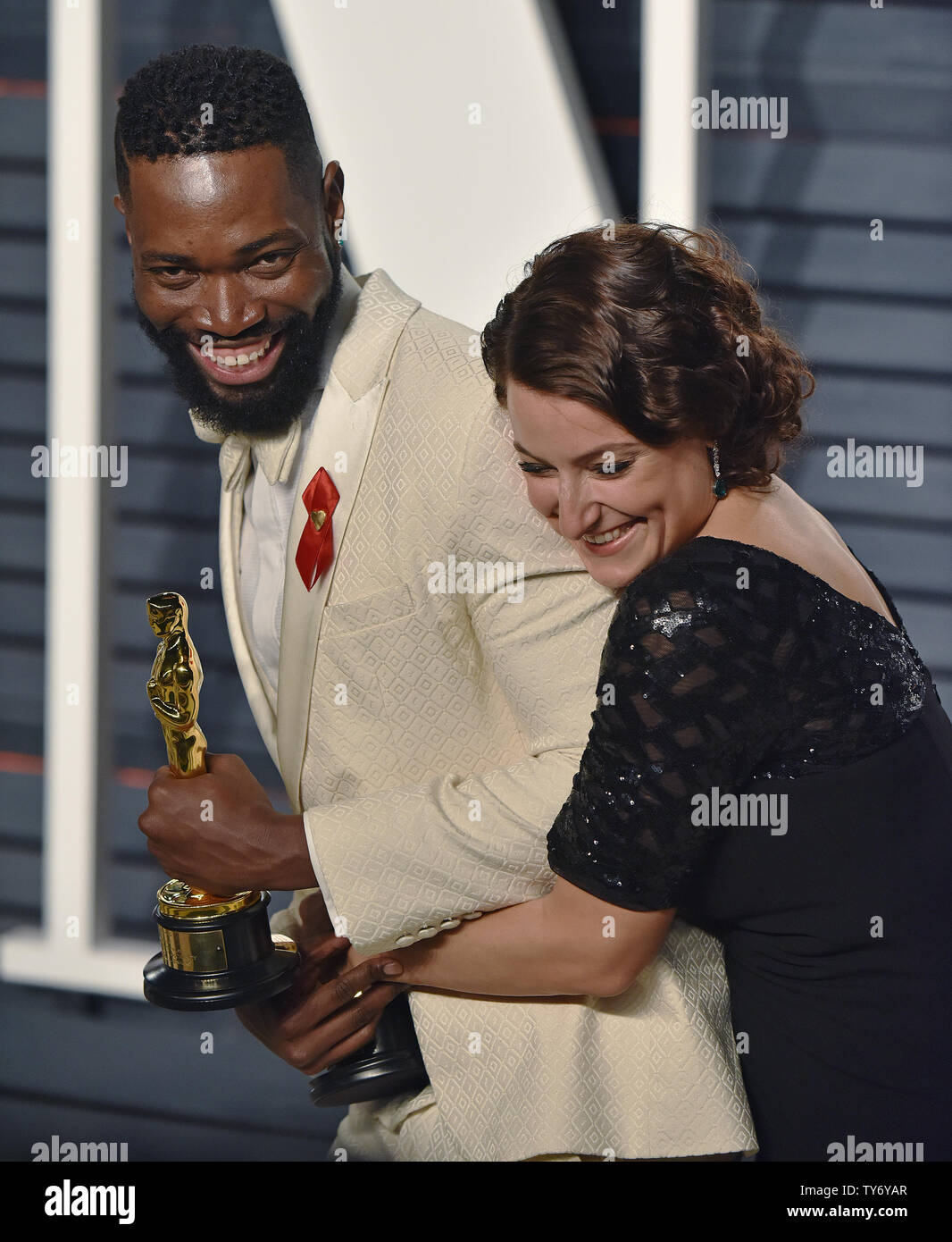 Writer Tarell Alvin McCraney (L) and producer Adele Romanski celebrate ...