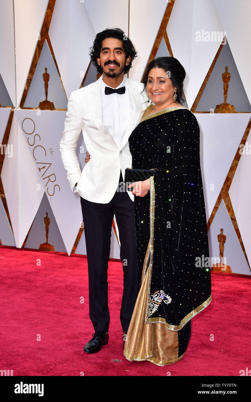 Dev Patel and his mother Anita arrive on the red carpet for the 89th ...
