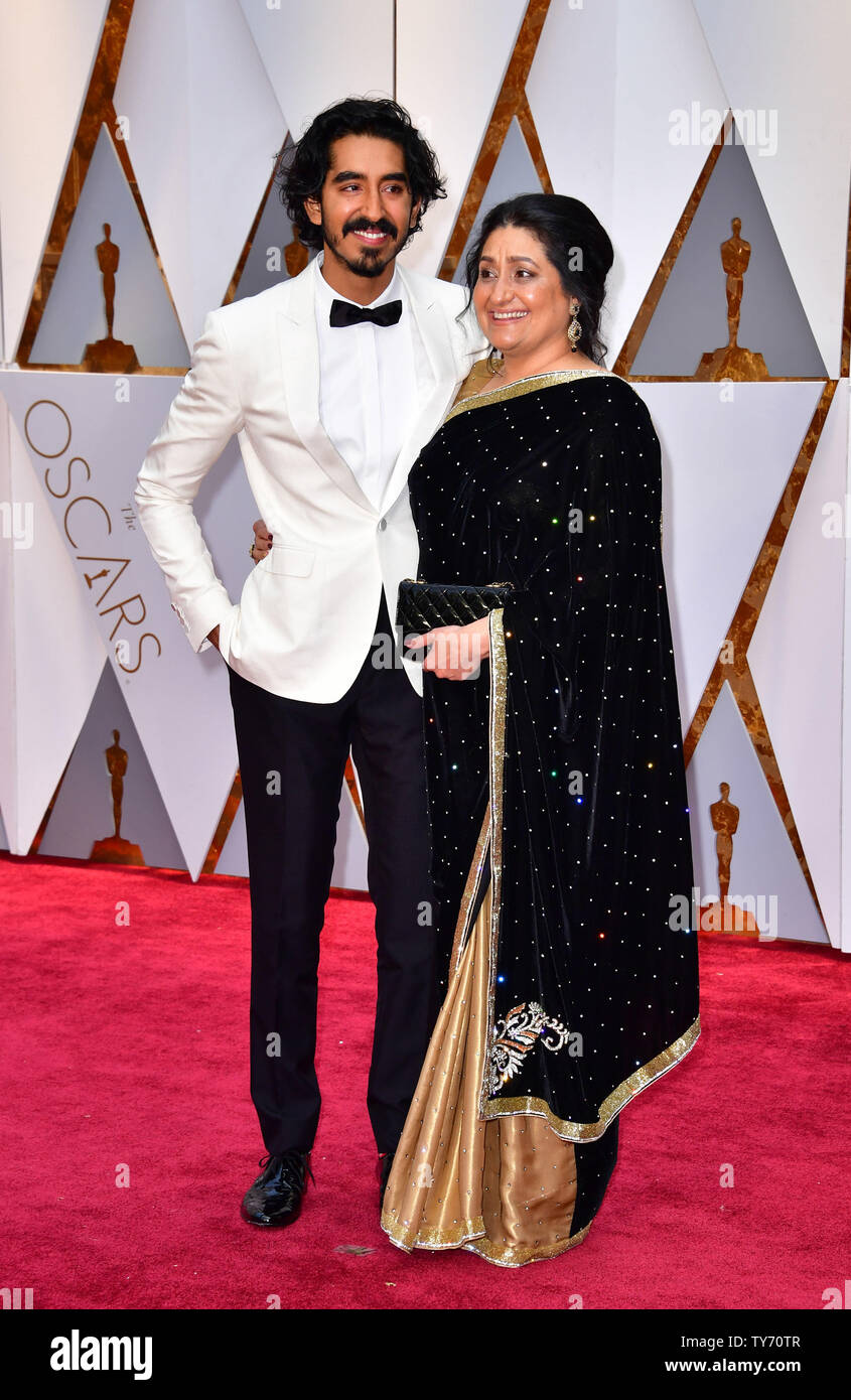 Dev Patel and his mother Anita arrive on the red carpet for the 89th ...