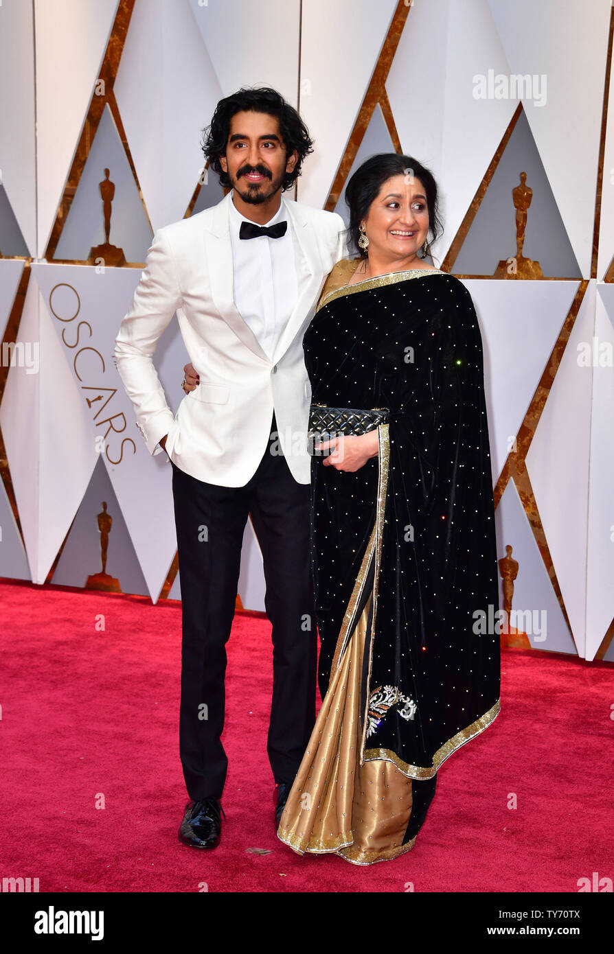 Dev Patel and his mother Anita arrive on the red carpet for the 89th ...