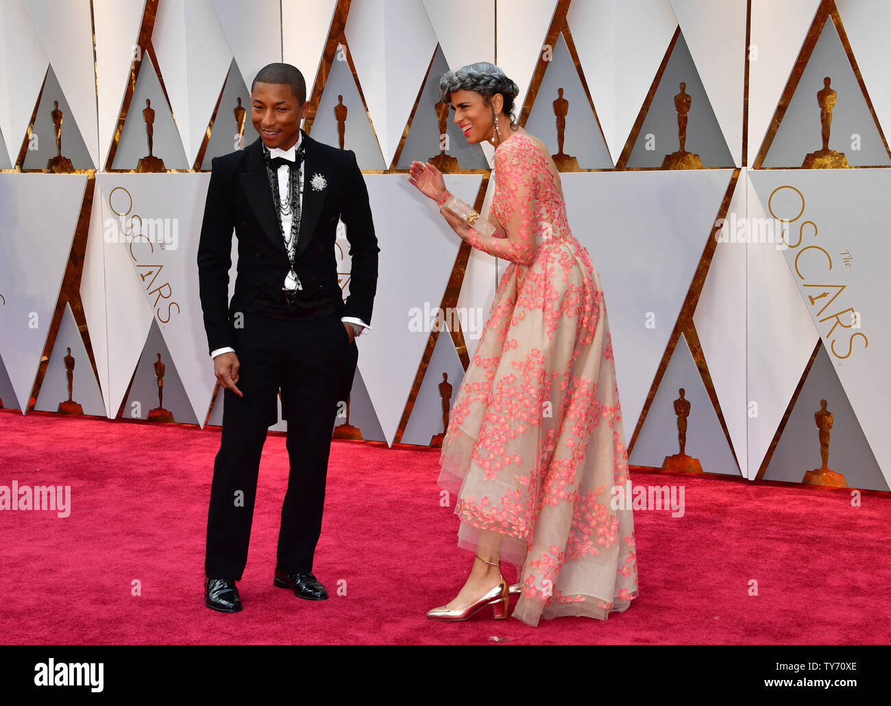 Pharrell Williams and Helen Lasichanh arrive on the red carpet for the ...