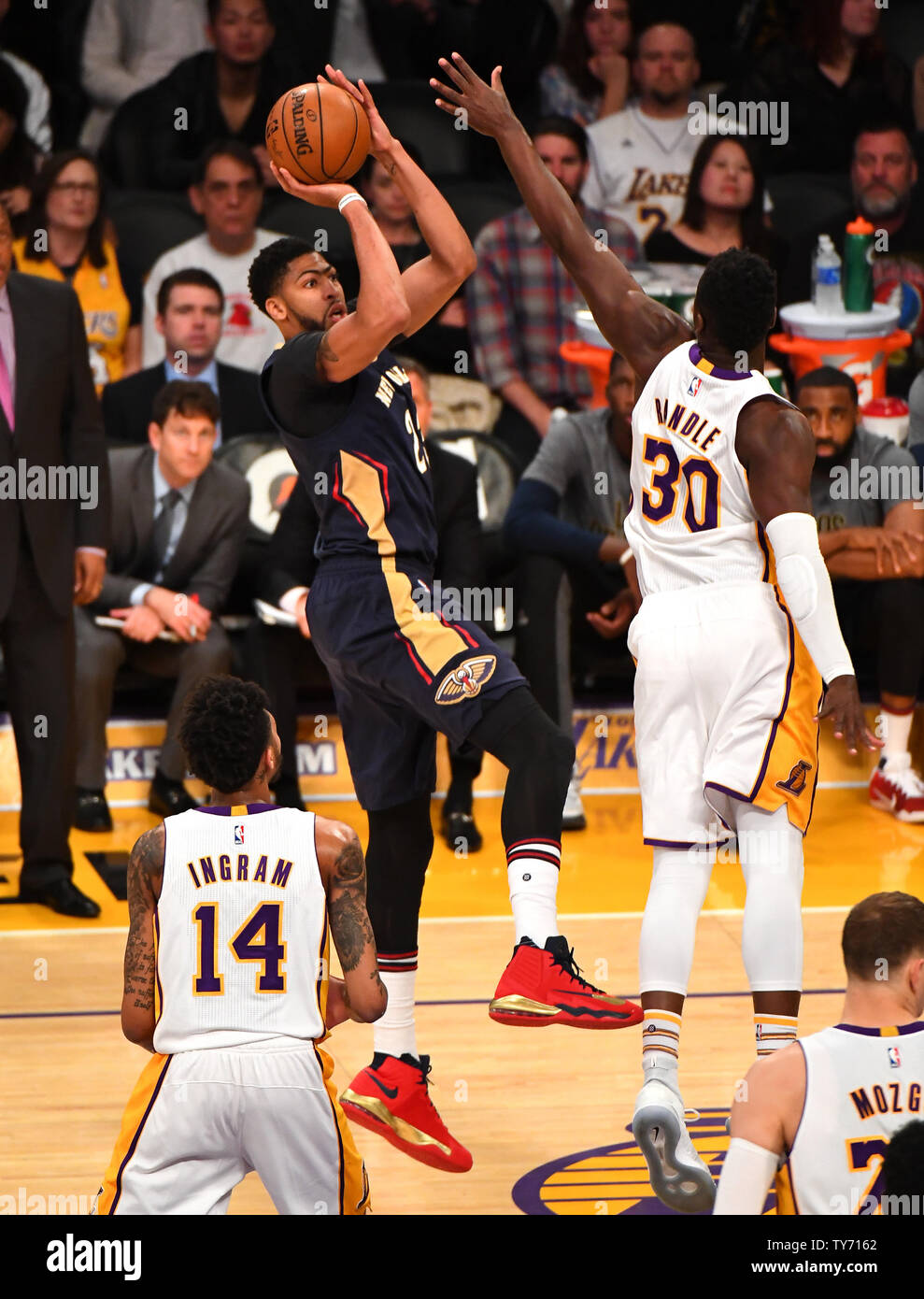 Pelicans forward Anthony Davis shoots over Laker forward Julius Randle ...