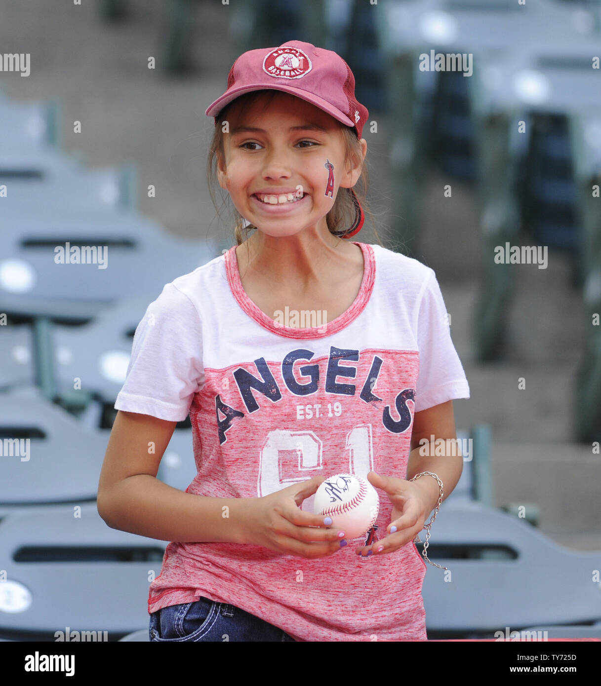 A fan is excited after getting her baseball signed by a Los Angeles ...