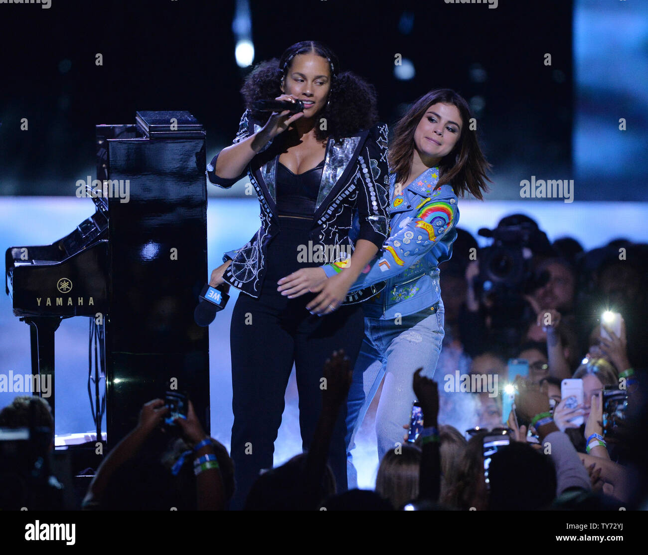 Singer Alicia Keys is joined onstage by show host Selena Gomez during ...