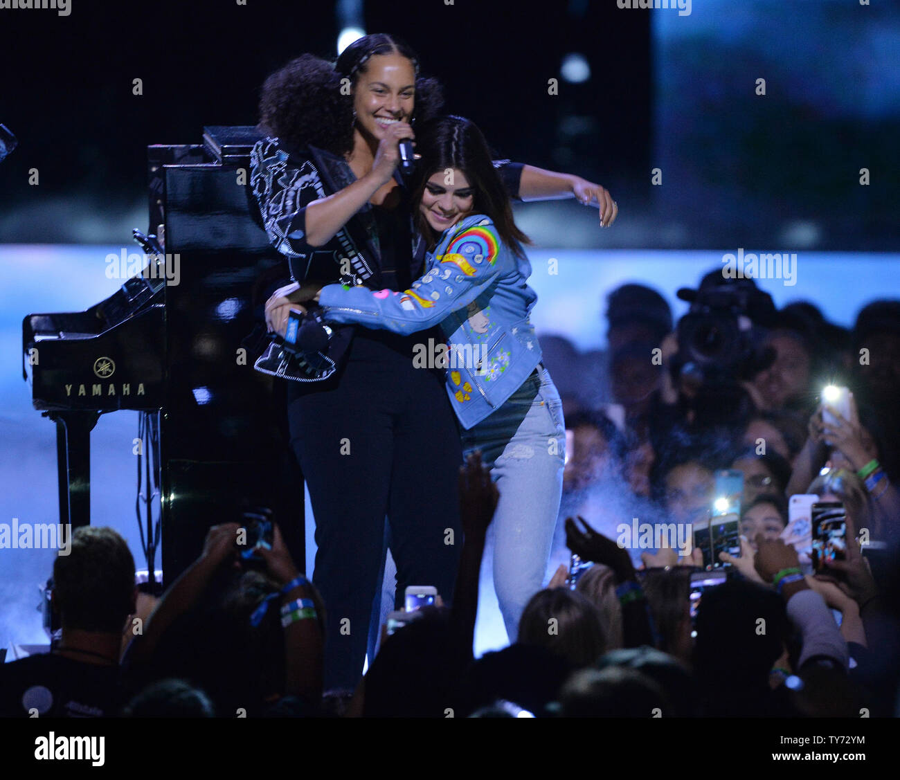 Singer Alicia Keys is joined onstage by show host Selena Gomez during ...