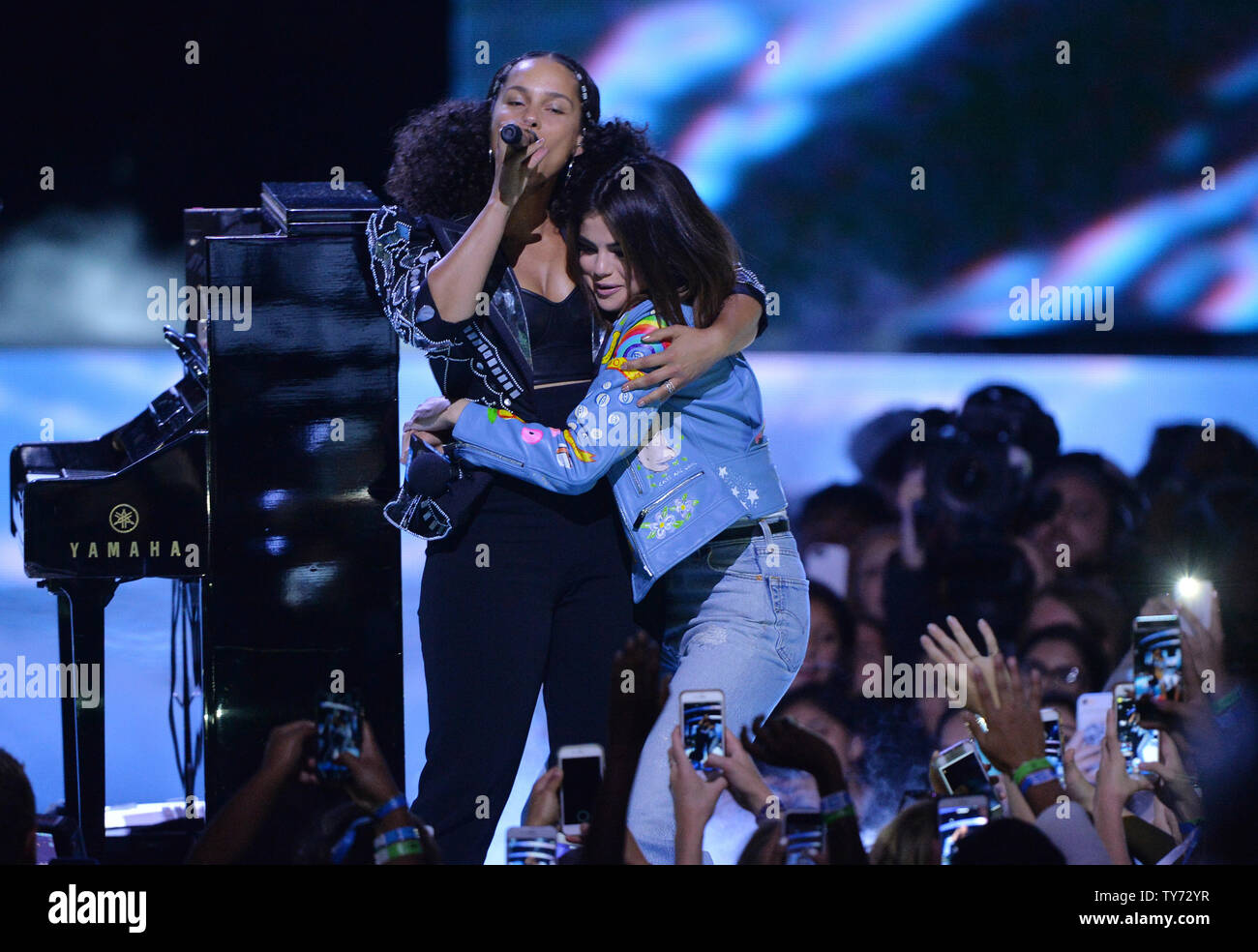 Singer Alicia Keys is joined onstage by show host Selena Gomez during ...