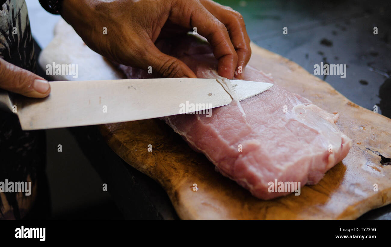Hands butcher cutting pork meat hi-res stock photography and images - Alamy