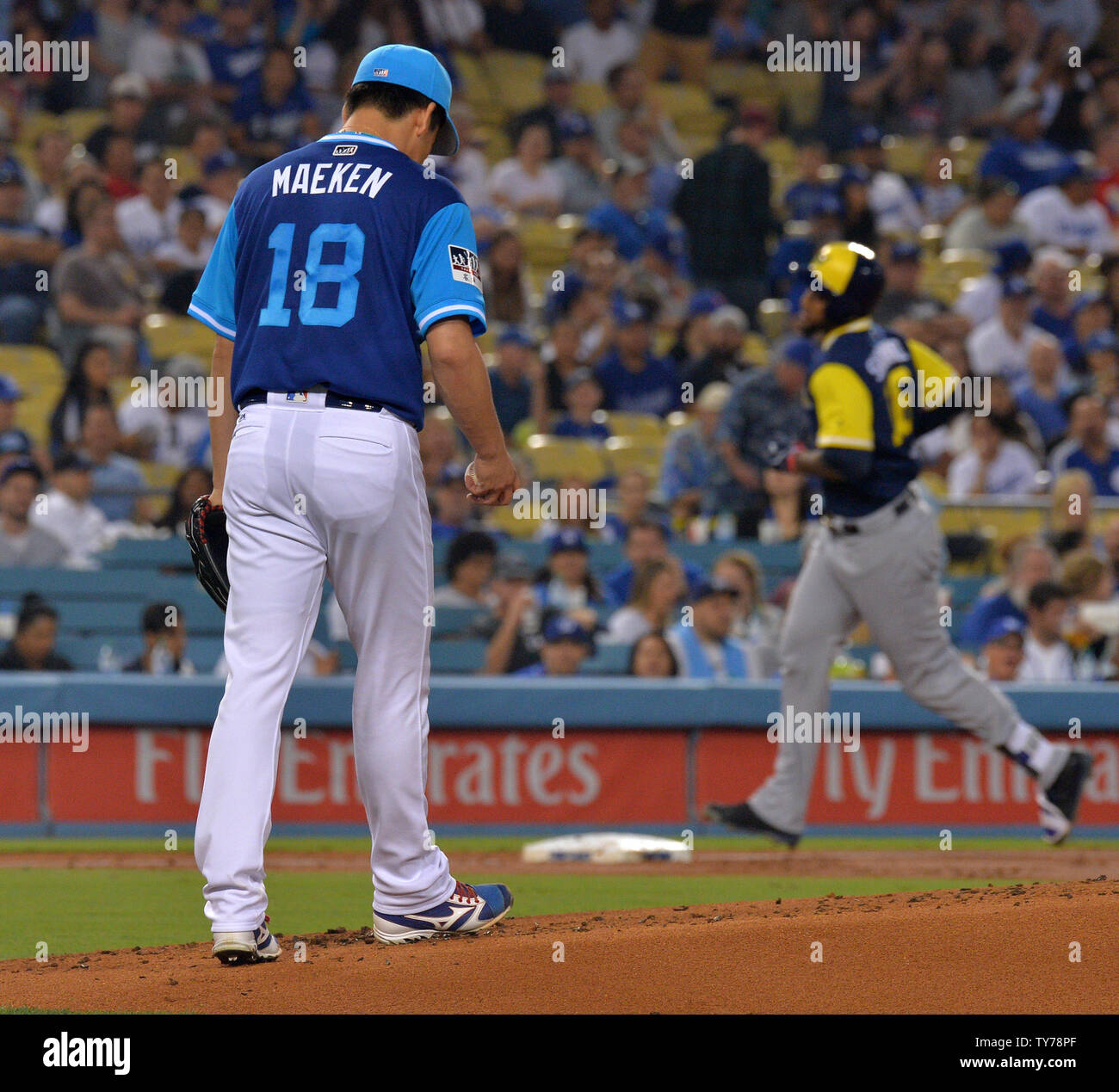 Los Angeles Dodgers' starting pitcher Kenta Maeda hangs his head after ...