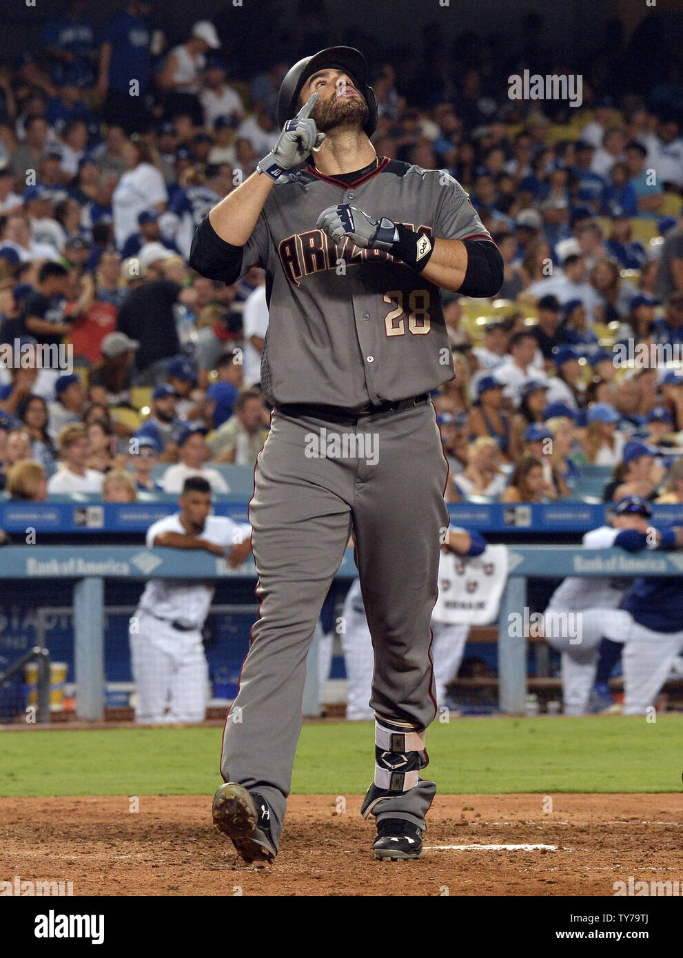 Diamondbacks' J.D. Martinez looks skyward after hitting the third of ...