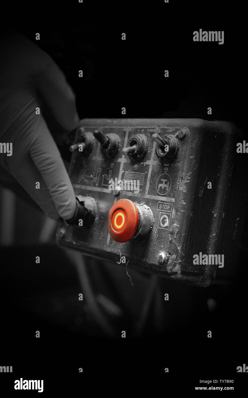 Man pressing button on an industrial machine control panel. With ...